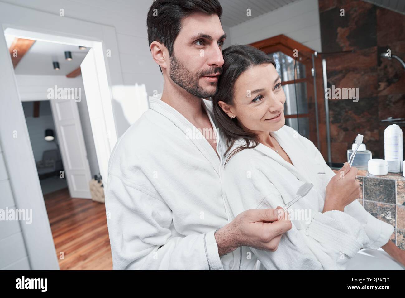 Couple in love brushing teeth together in hotel Stock Photo - Alamy