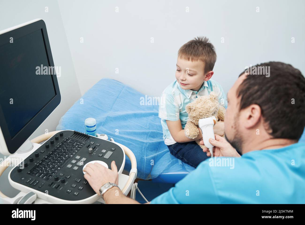 Caucasian boy carefully observing what medical worker doing Stock Photo ...