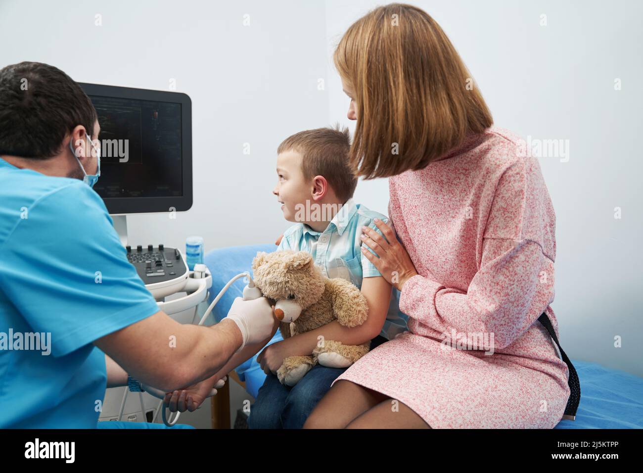 Caucasian boy with his mother at doctor appointment for vascular arm ...