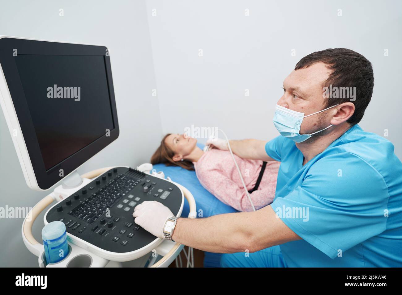 Caring endocrinologist performing an ultrasound examination of woman ...