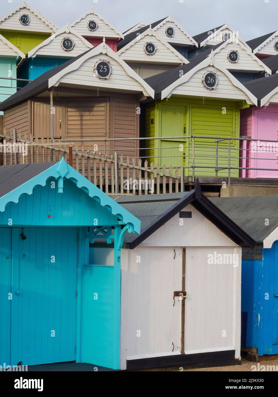Tiers of colourful timber beach huts, ready for holiday makers, forming ...