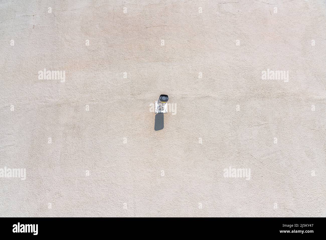 Lone security camera on a wall at San Jose, California. Wall-mounted ...