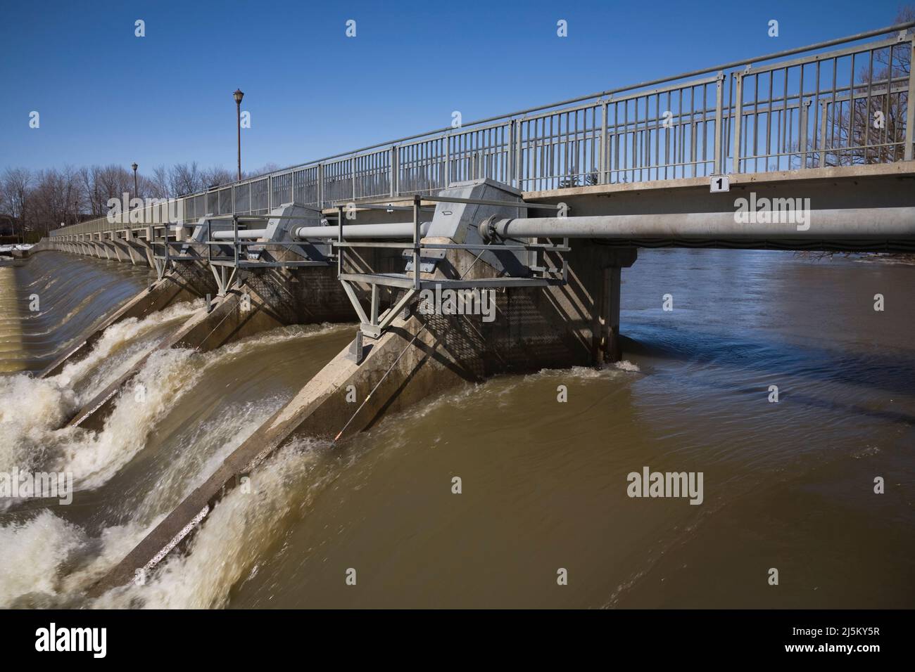 Polluted water gushing through a water flow control gate on the Mille ...