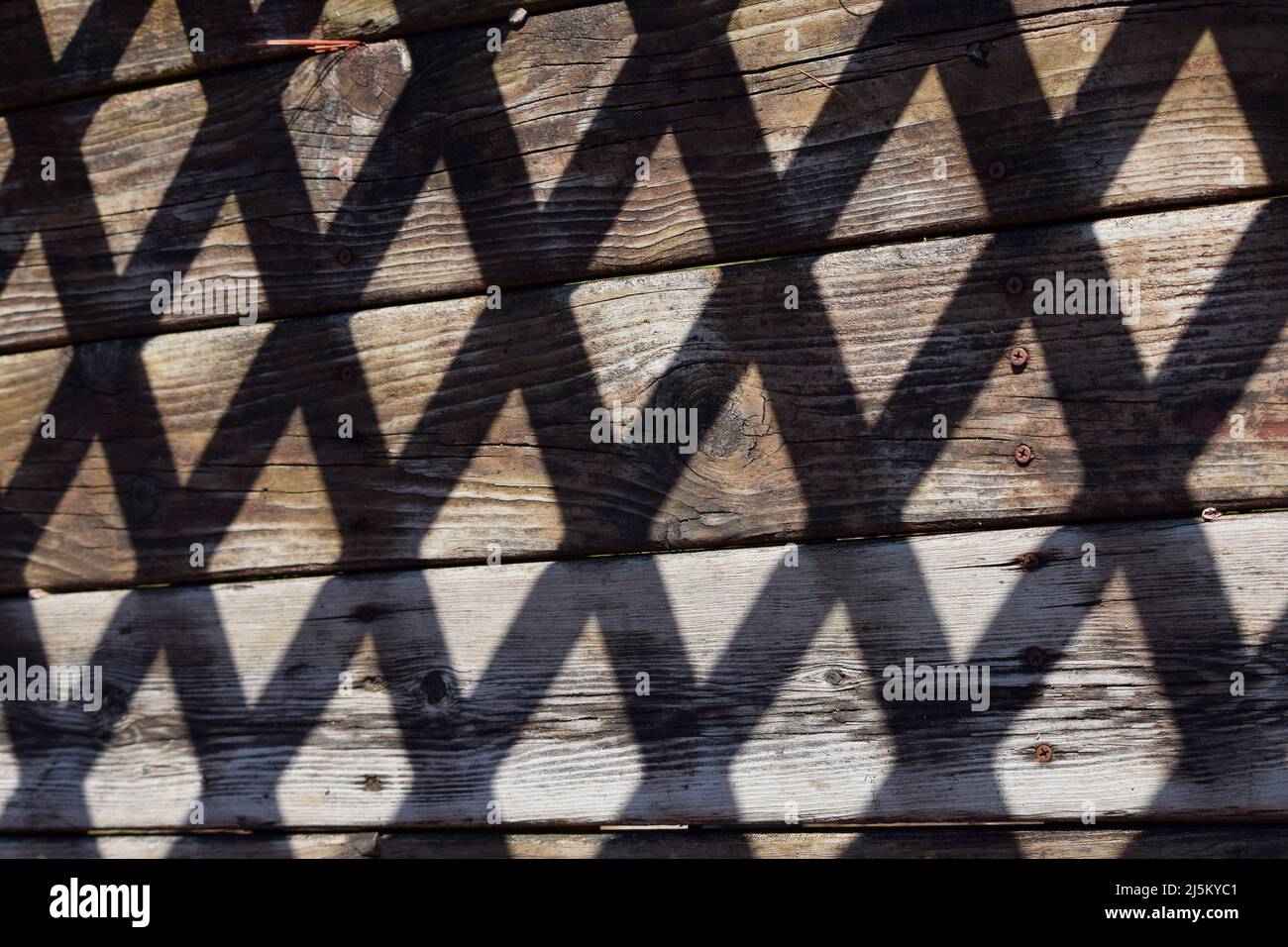 Shadow cast by wood lattice on a wooden deck Stock Photo - Alamy