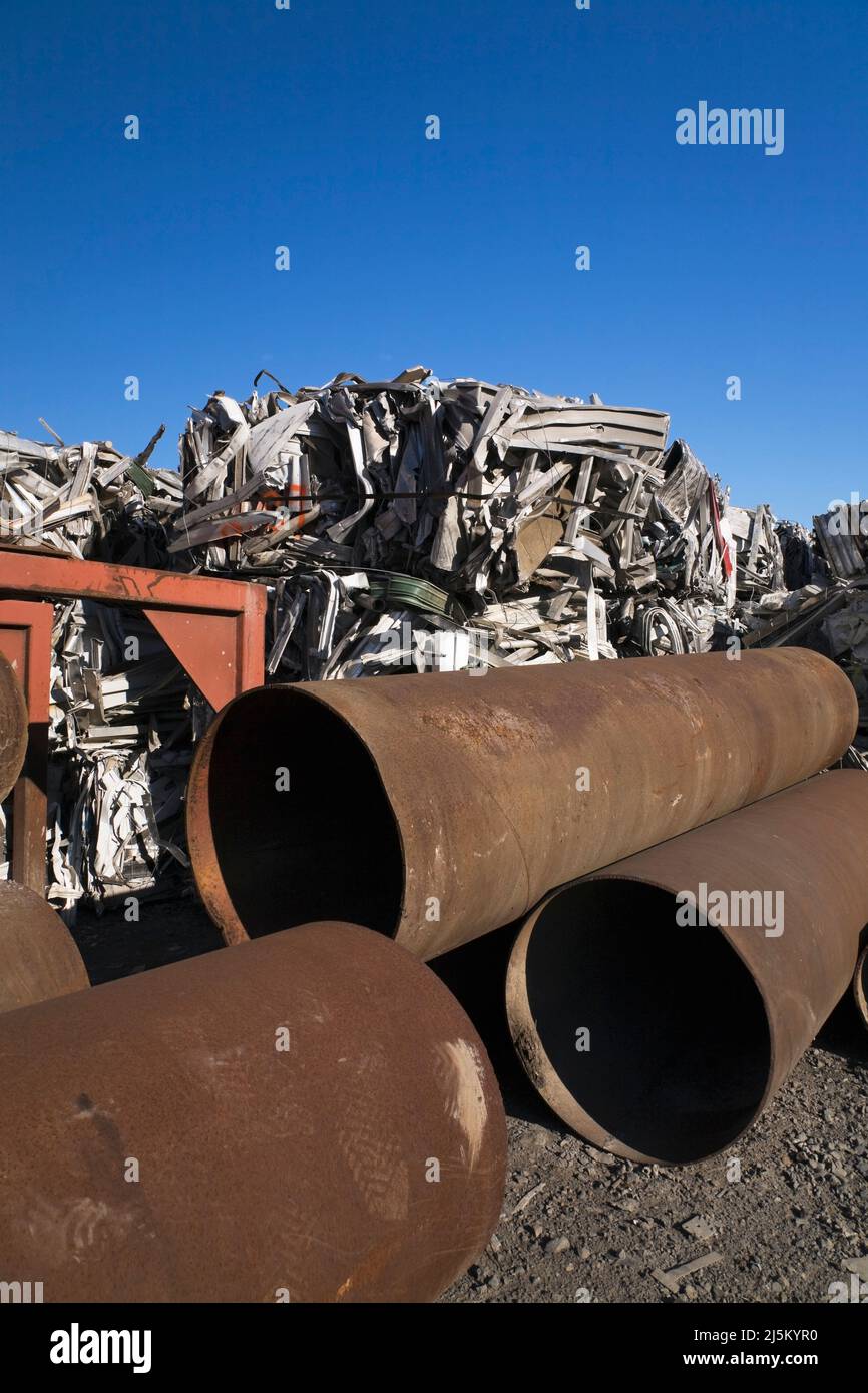 Large metal pipes and bales of crushed and compacted pieces of various ...