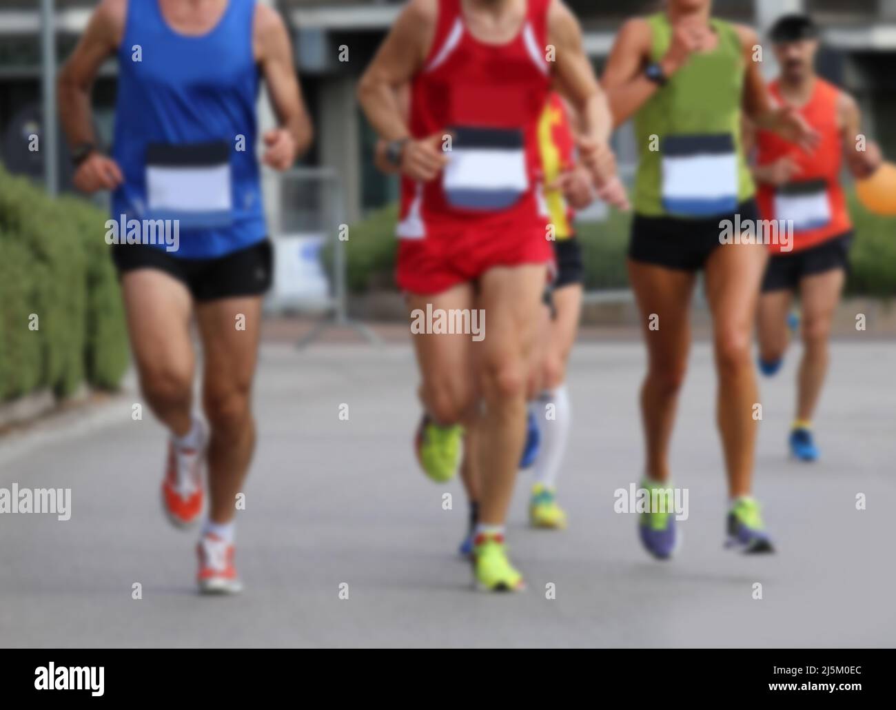 Intentionally blurred group of athletes runners during foot race in the ...