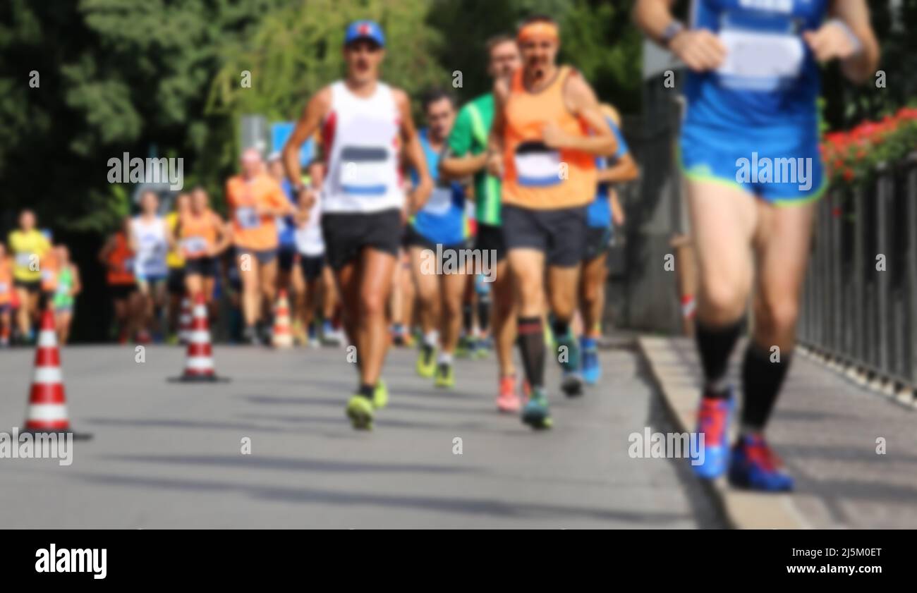 Intentionally blurred group of athletes runners during foot race in the ...