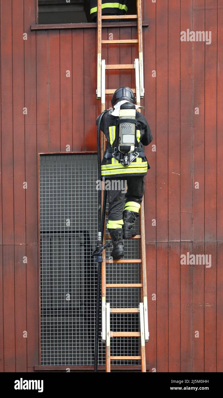 firefighters in action in the fire station with self-contained ...