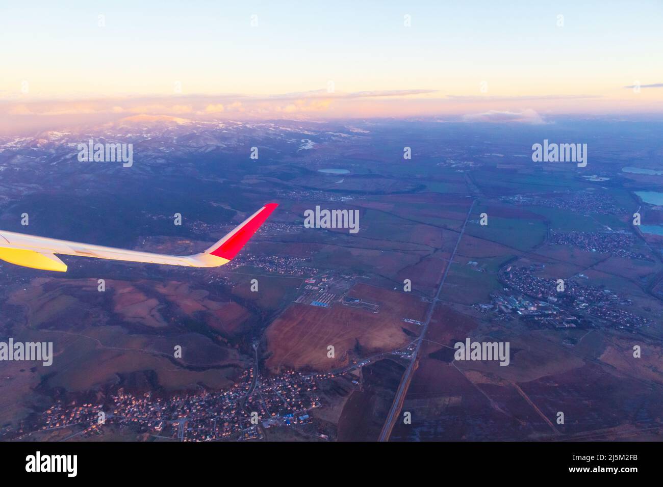 Sunset sky over Sofia valley and Balkan Mountains in Bulgaria seen from flying airplane,December ...