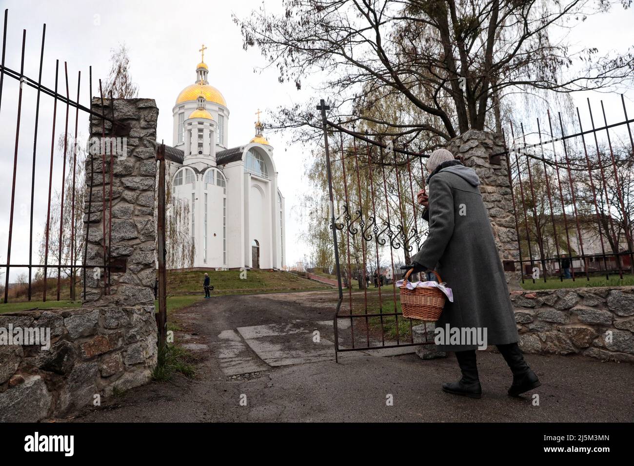 Bucha, Ukraine - April 24, 2022 - A woman carrying an Easter basket ...
