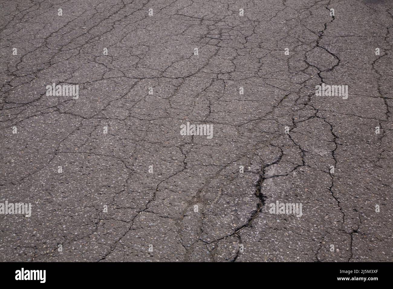 Close-up of cracked asphalt pavement Stock Photo - Alamy
