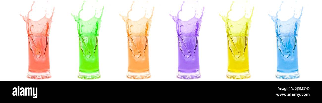 Fun arrangement of different colored splashing mugs Stock Photo - Alamy