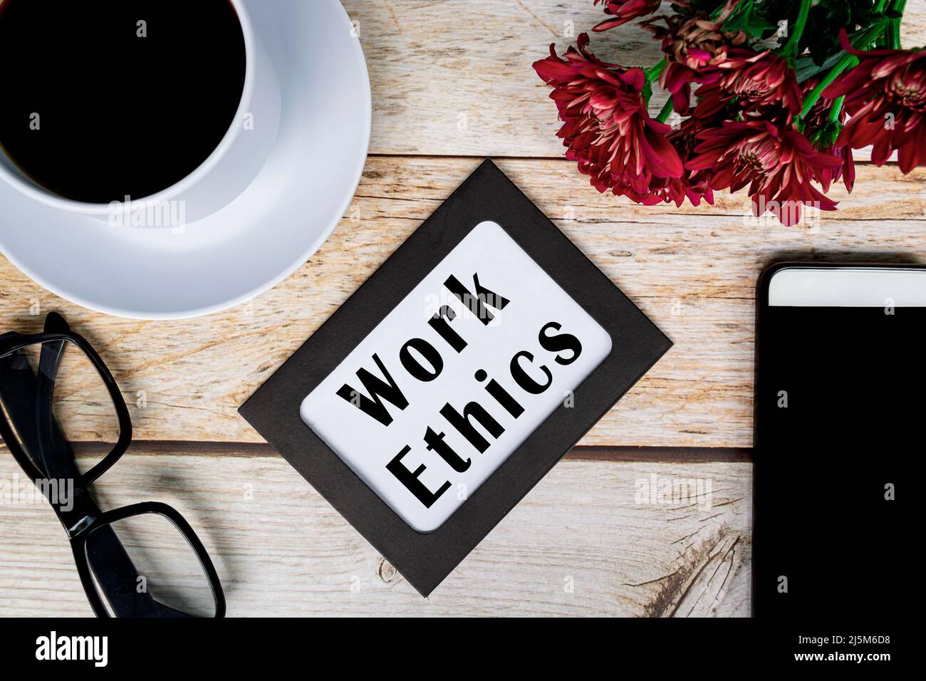 Work Ethics text on chalkboard frame on wooden desk. Directly above ...