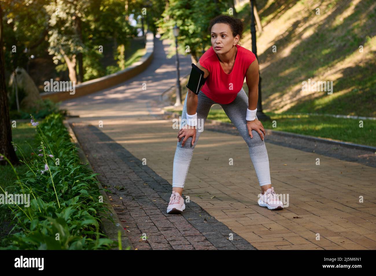 Exhausted female runner in race hi-res stock photography and images - Alamy