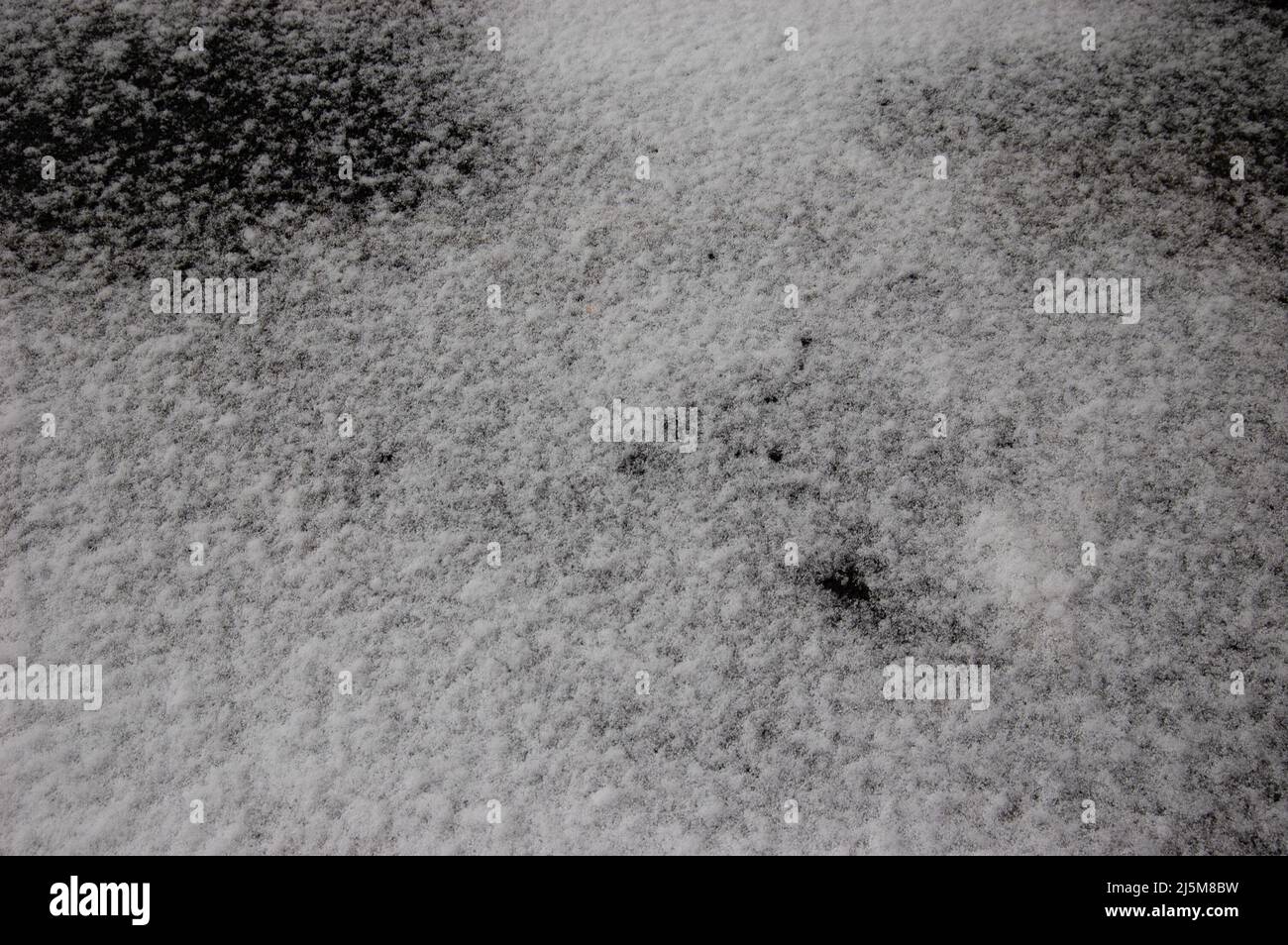 Winter background: black ground covered with white snow Stock Photo - Alamy