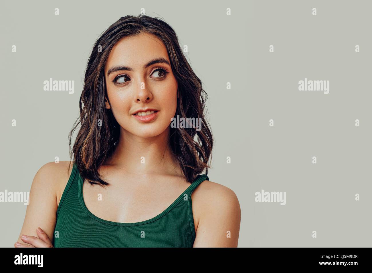 Young woman looking to the side at copy space studio portrait Stock ...