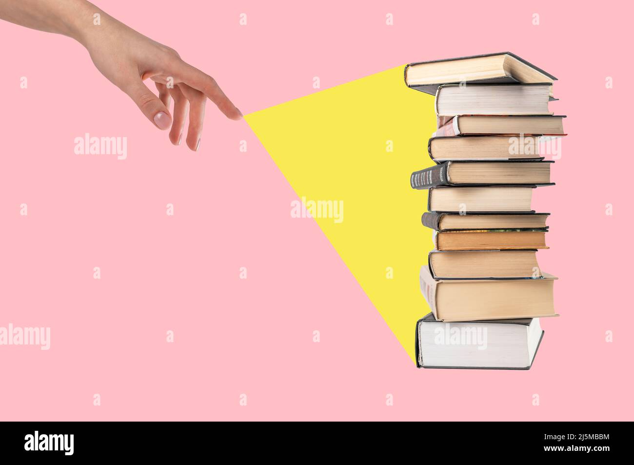 Light ray coming from woman hand to books stack on pink background ...