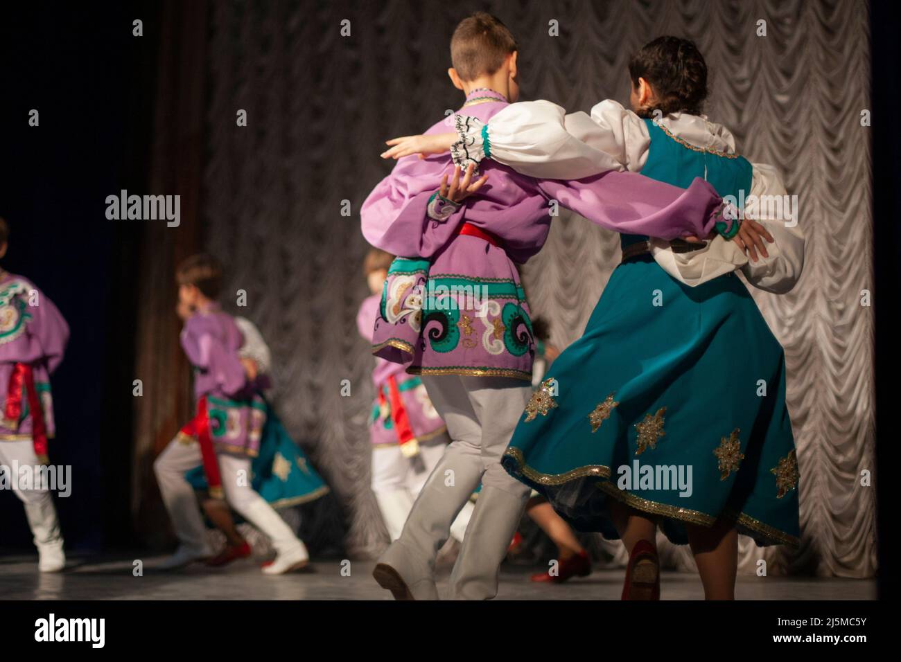 They dance in folk costumes. Russian children dance in sarafans ...