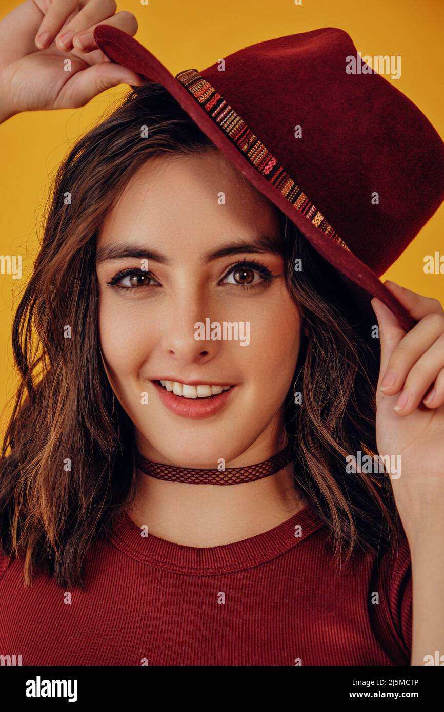 Close up young woman looking at camera with red hat studio portrait ...