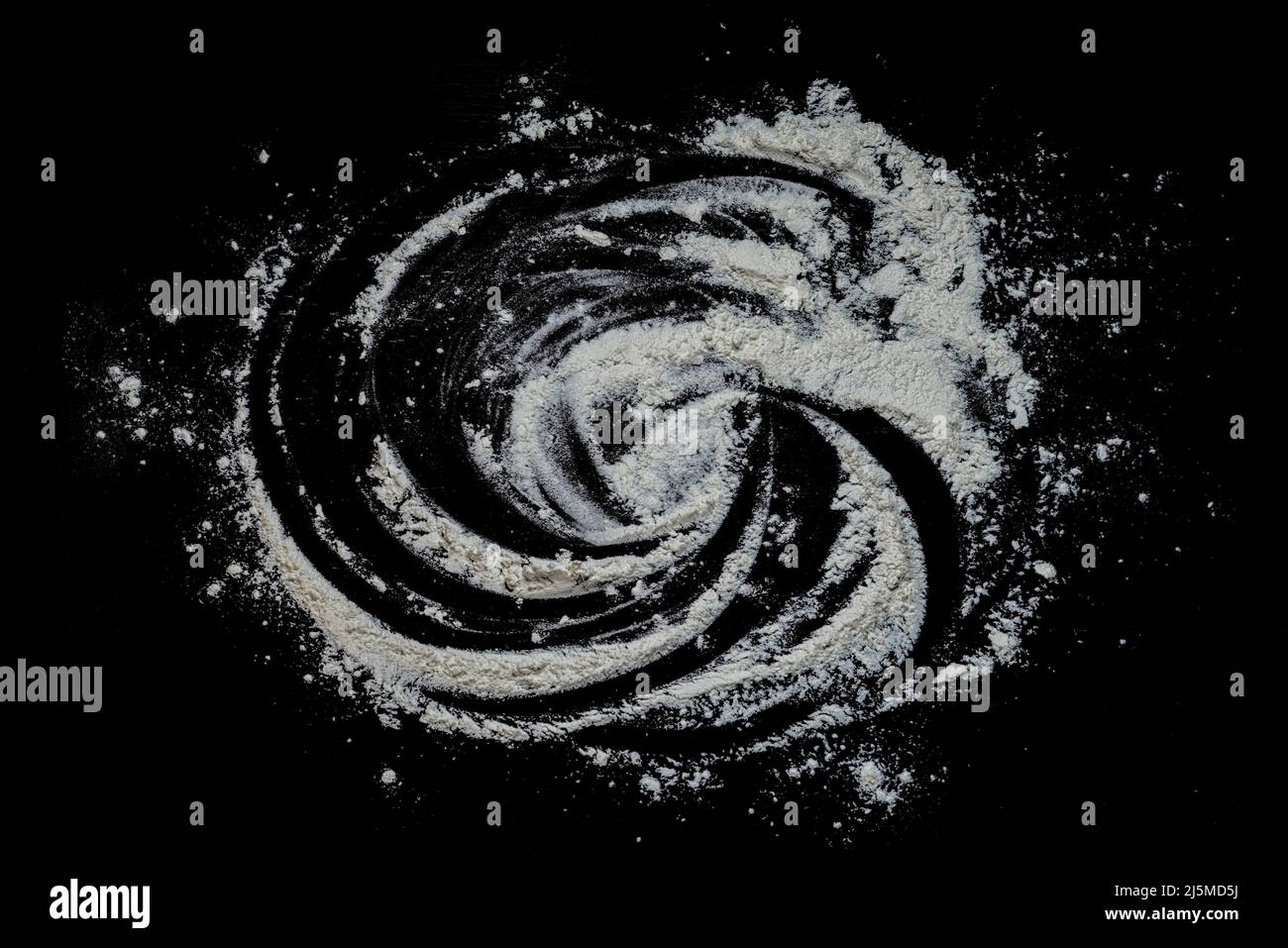 Black background sprinkled with flour, smeared flour, table for cooking ...