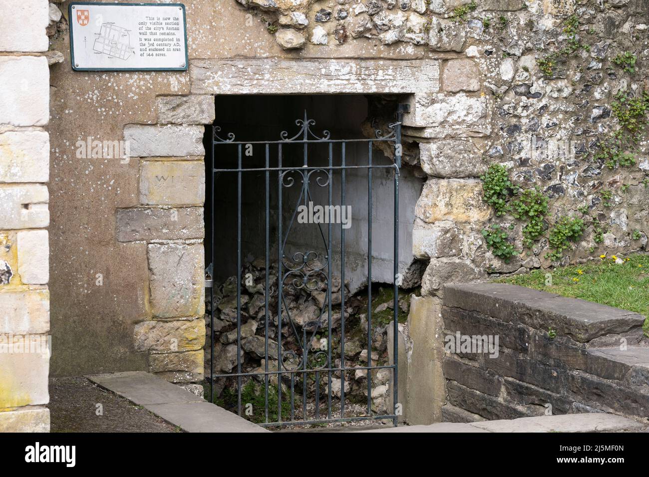 A plaque reading "This is now the only visible section of the city's ...