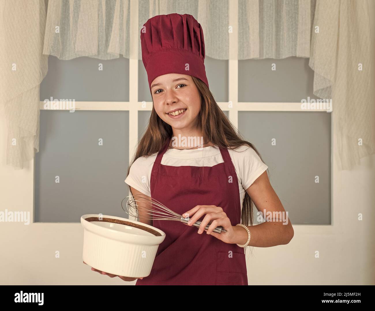An amazing experience. kid cooking food in kitchen. choosing a career ...