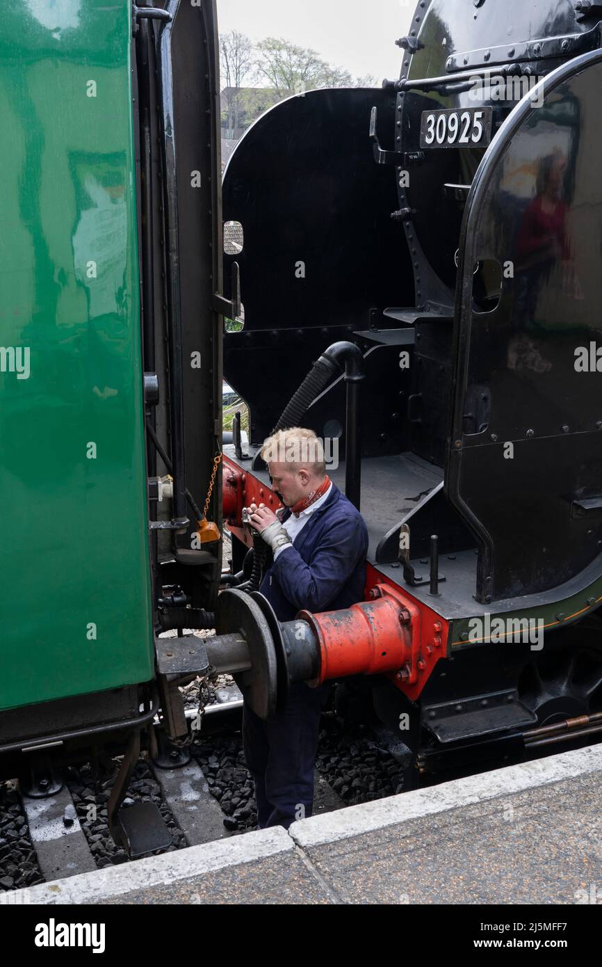 An engineer uncoupling the 30925 steam locomotive from its carriages on ...