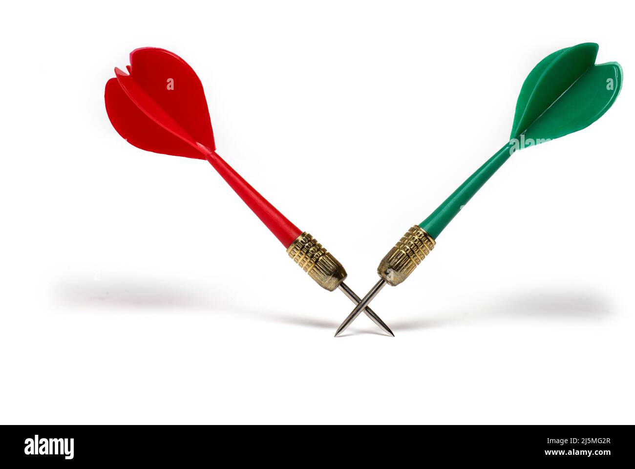 Close up of two plastic darts in red and green color crossed in the ...