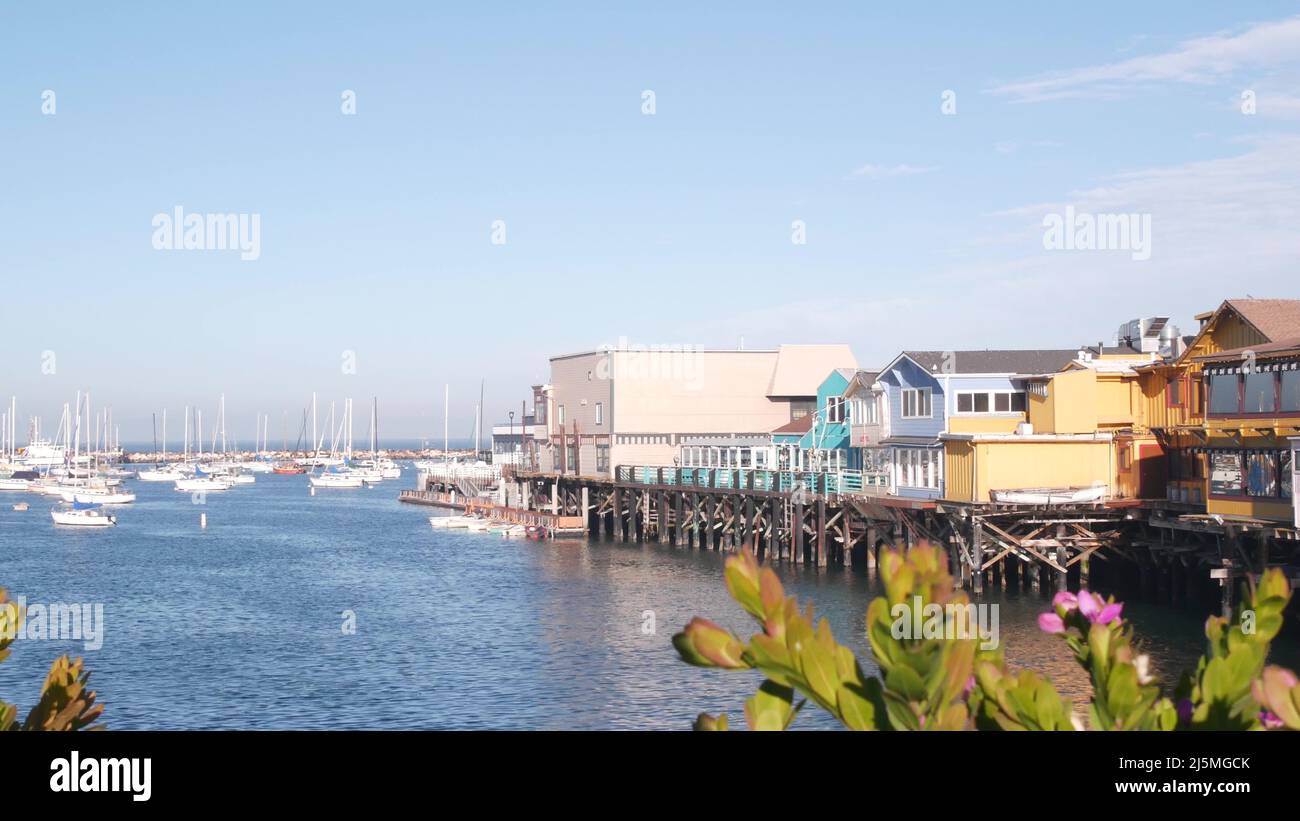 Colorful wooden houses on piles or pillars, ocean bay or harbor, sea ...
