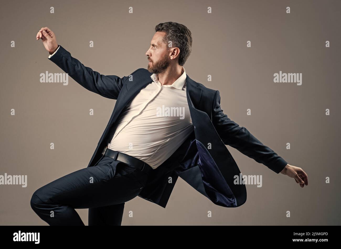 happy businessman wearing formal suit dancing in office celebrating ...