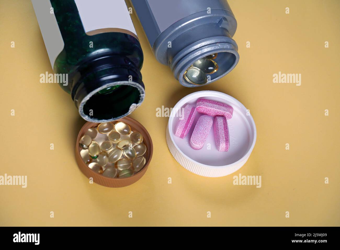 Vitamin food supplement pills inside open plastic containers Stock ...