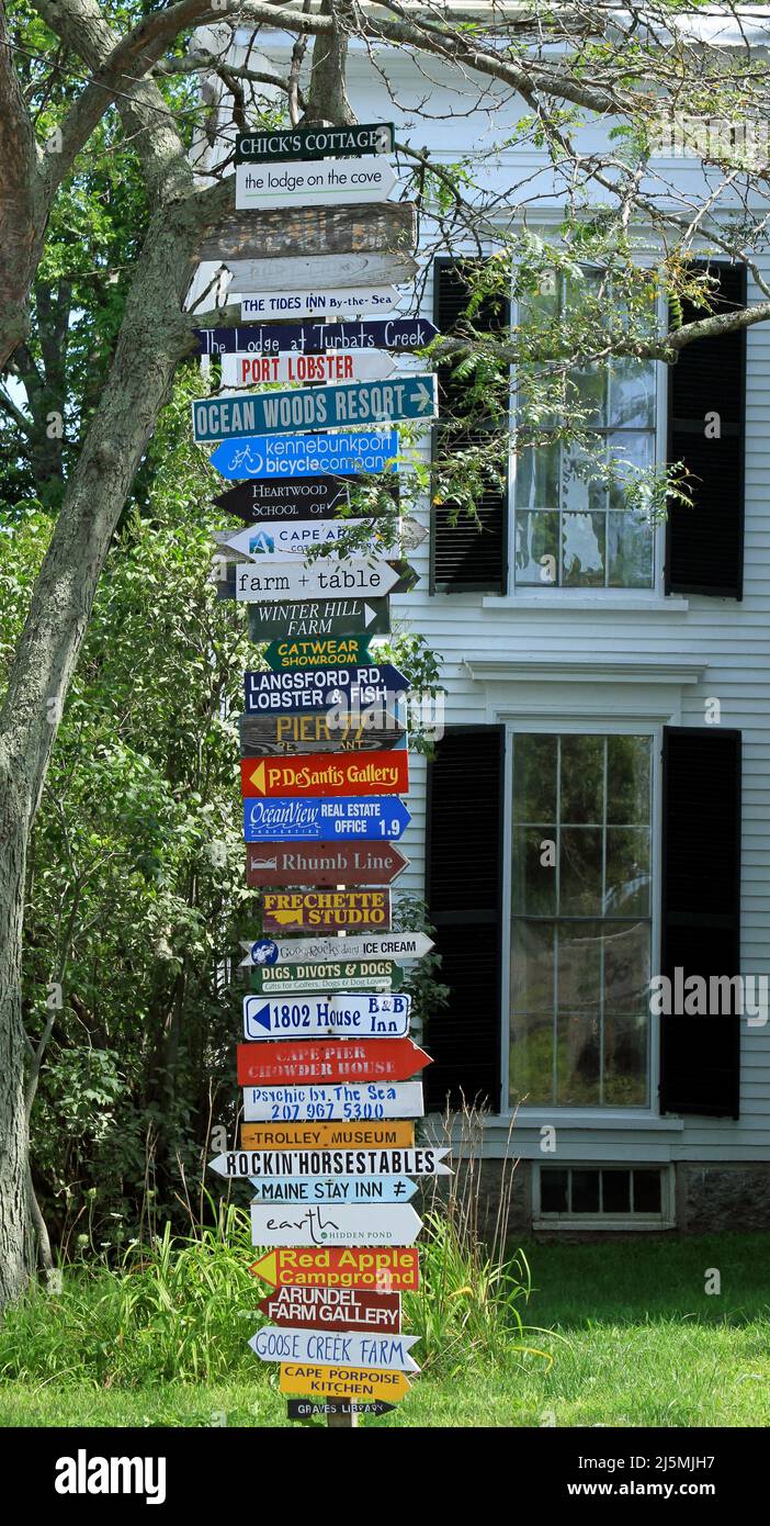 Signpost directions with arrows pointing to local businesses in ...