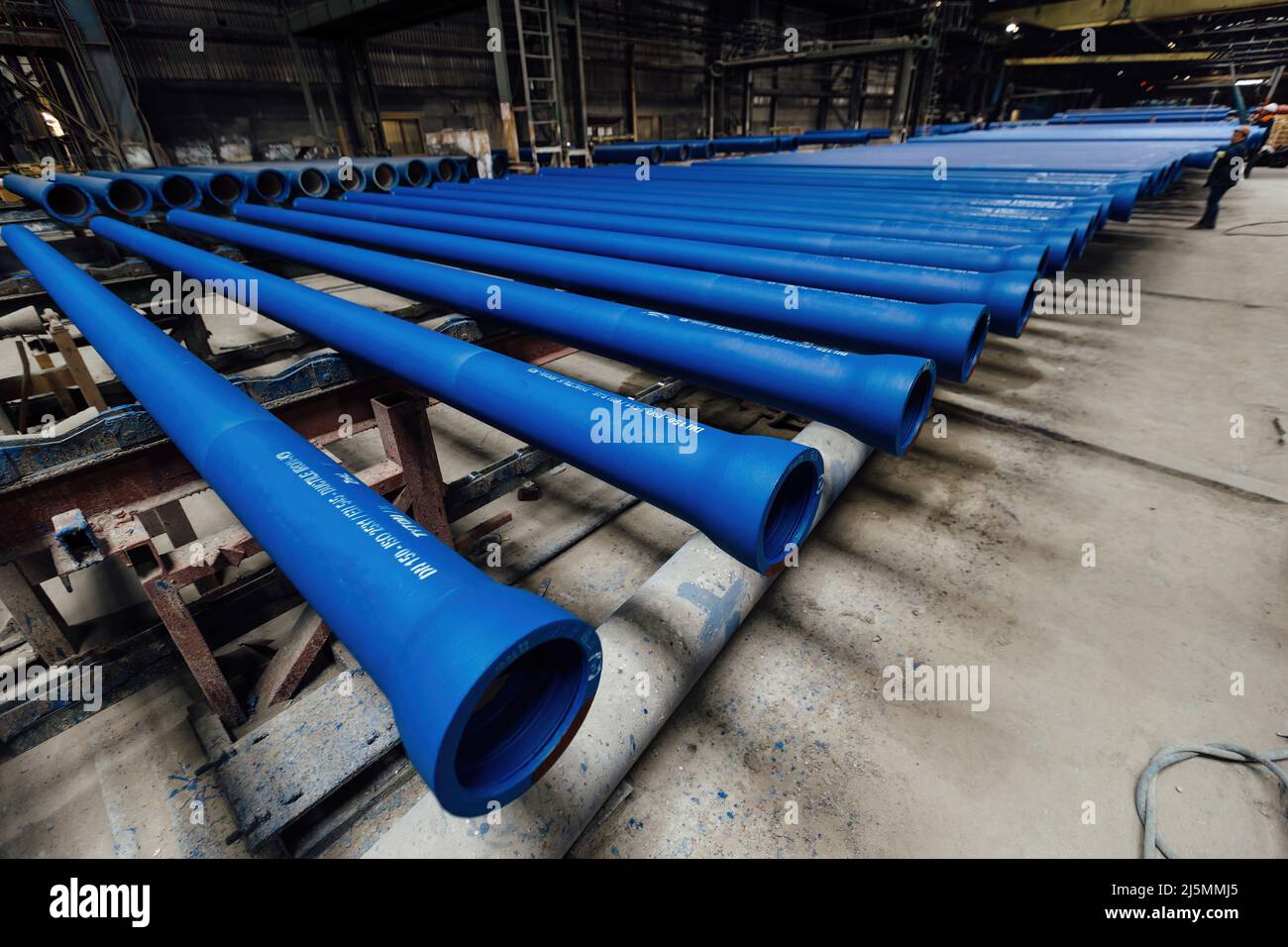 New cast iron pipes for pipeline construction in warehouse Stock Photo ...