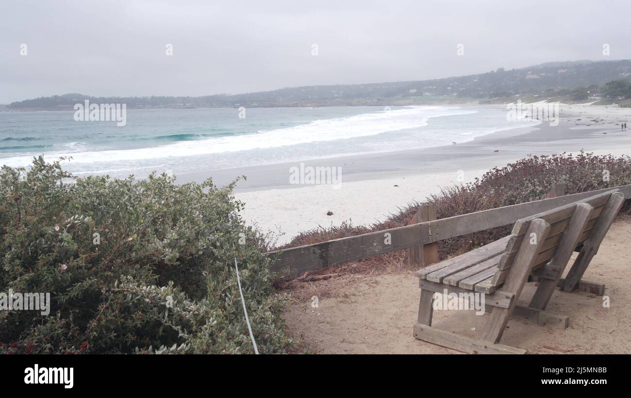 Empty wooden bench, rest on trail path, walkway or footpath. Carmel ...