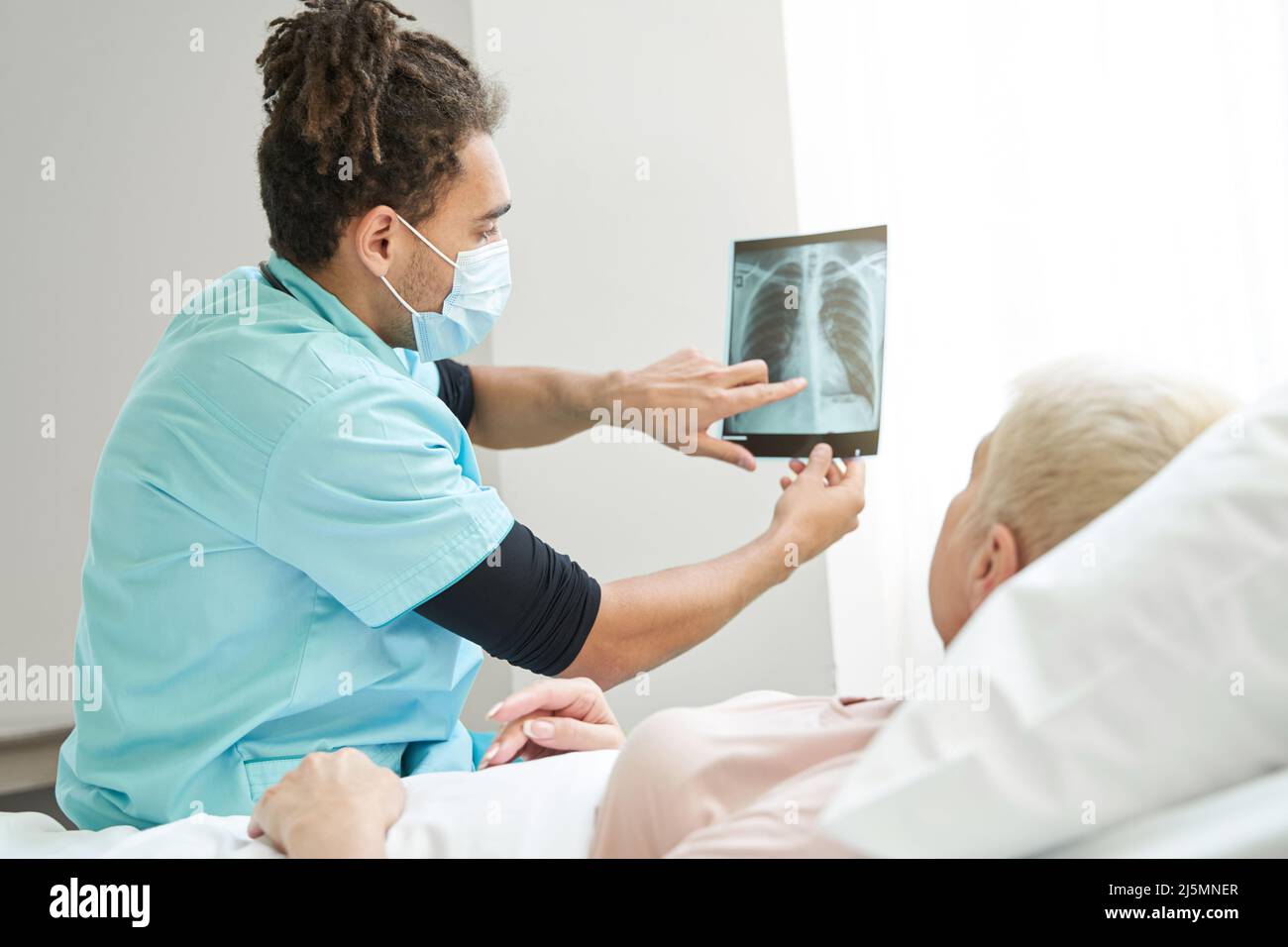 Medical worker pointing out a problem on x-ray radiograph Stock Photo ...