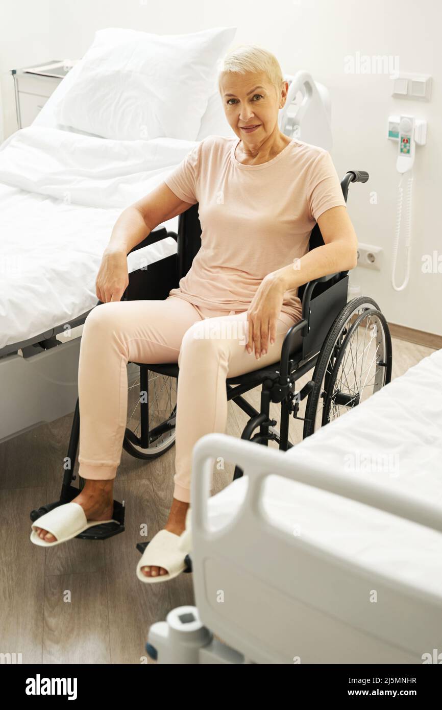 Woman with disability sitting in wheelchair in hospital Stock Photo - Alamy