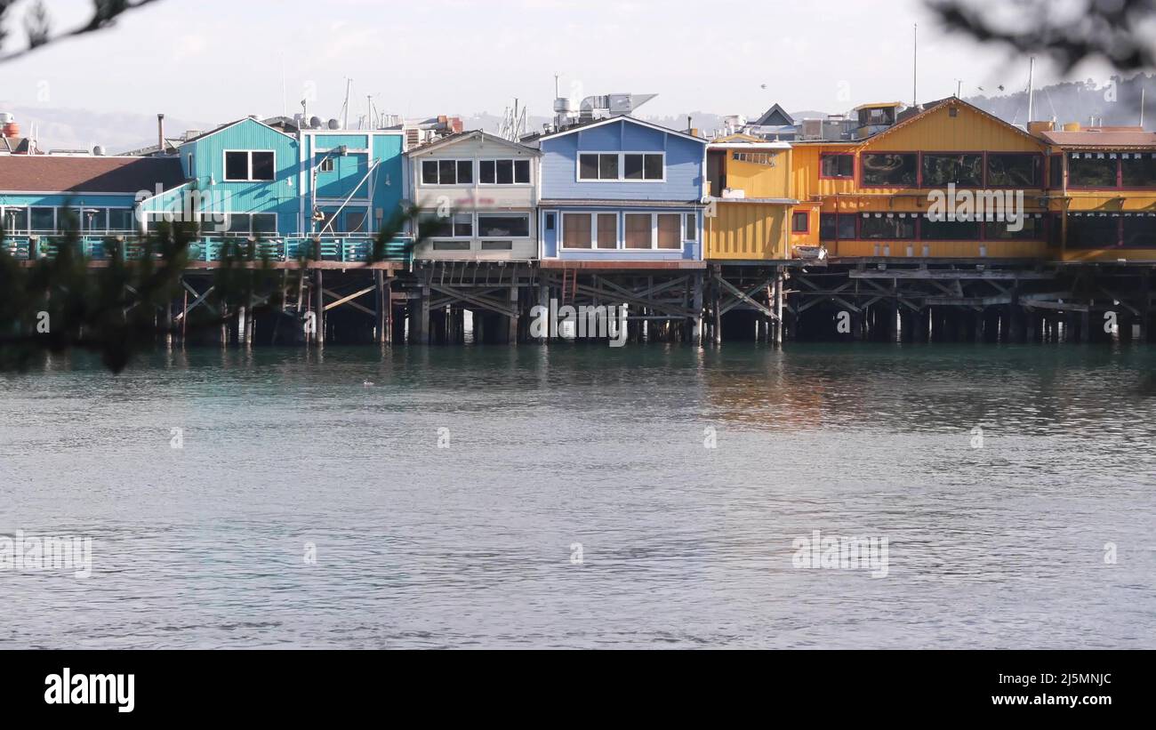 Colorful wooden houses on piles, pillars or pylons, ocean sea water ...