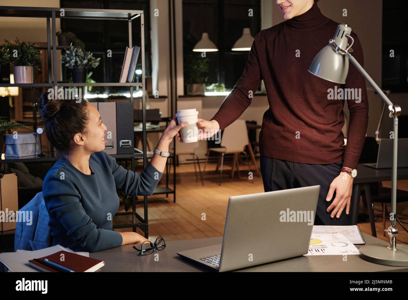 Man giving cup to women at work hi-res stock photography and images - Alamy