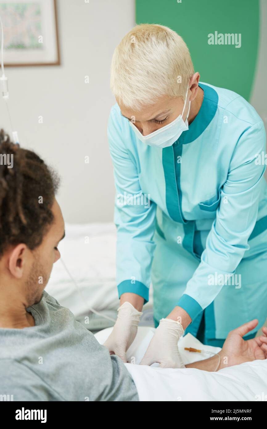 Medical therapist putting needle into patient arm Stock Photo - Alamy