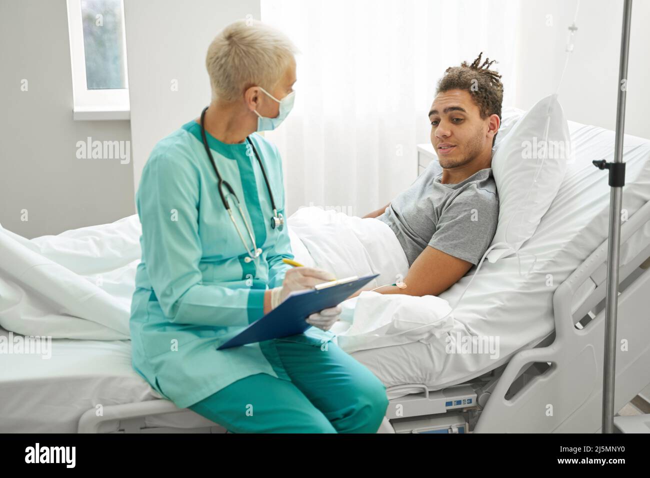 Male patient looking at doctor notes with interest Stock Photo - Alamy