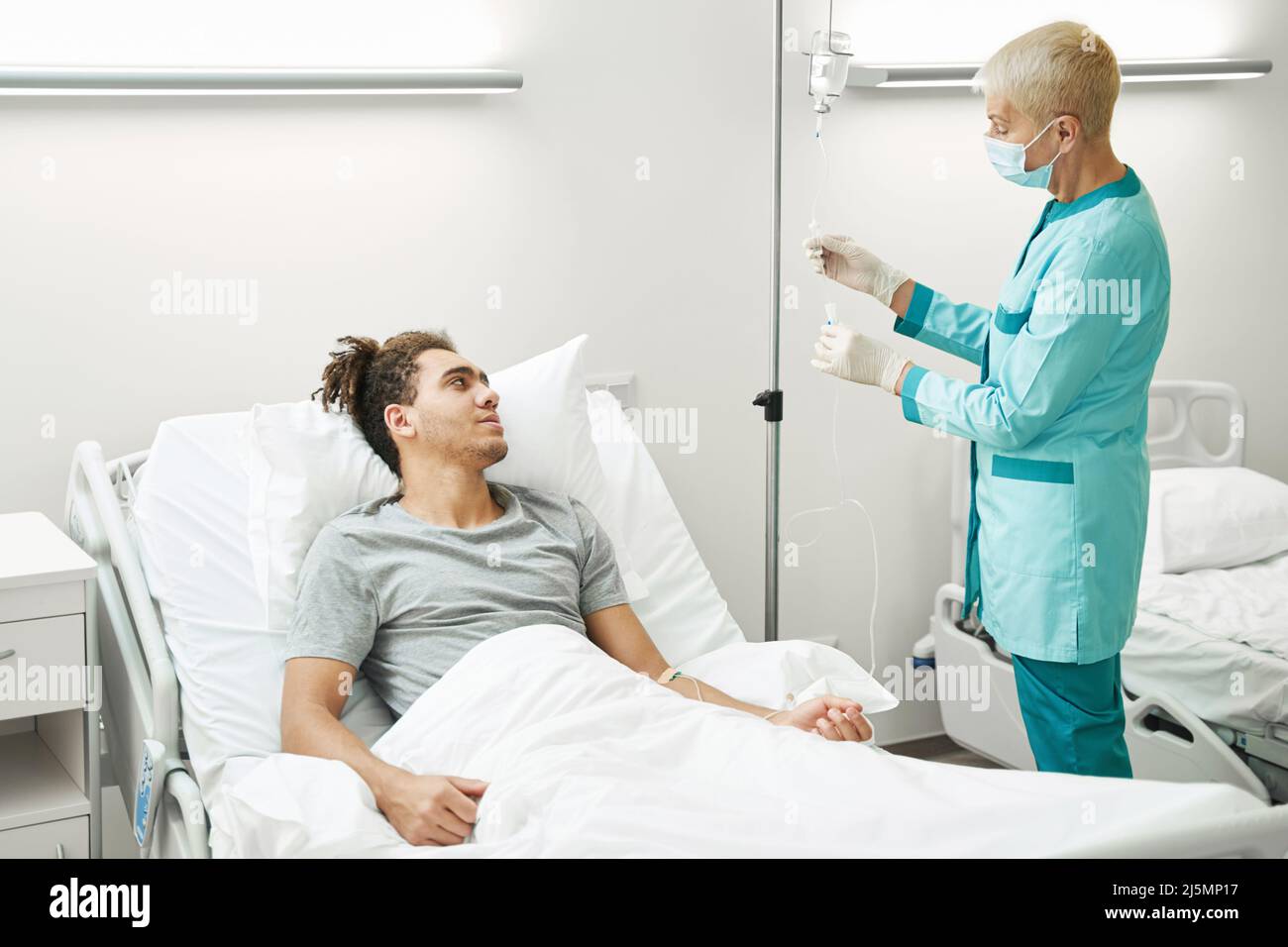 Medical professional using drip chamber of intravenous line Stock Photo ...