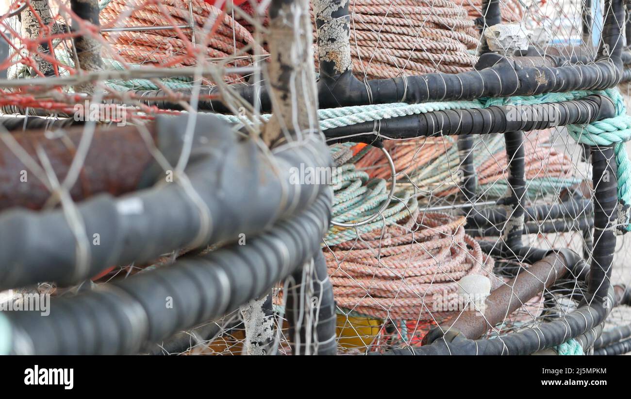 Traps, ropes and cages on pier, commercial dock, fishing industry ...