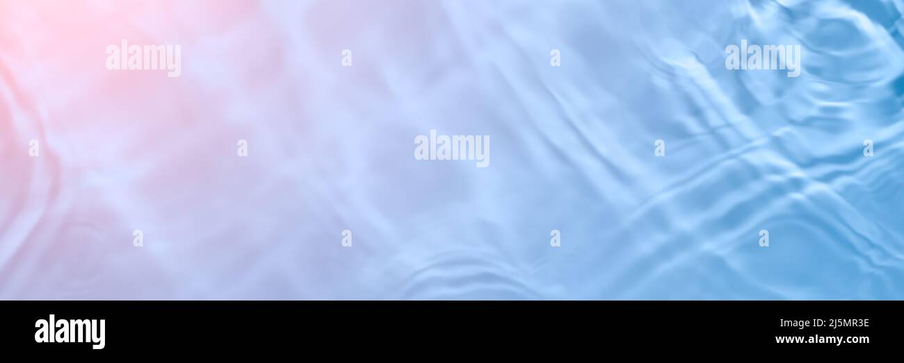 Serum or water texture close up. Light blue and pink gradient liquid ...