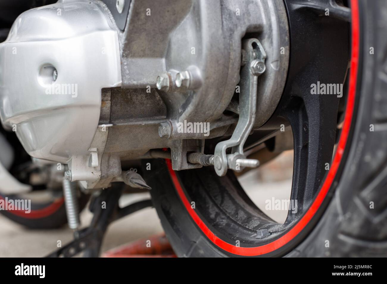 The rear wheel of a motorbike with a gearbox, a brake mechanism and a ...