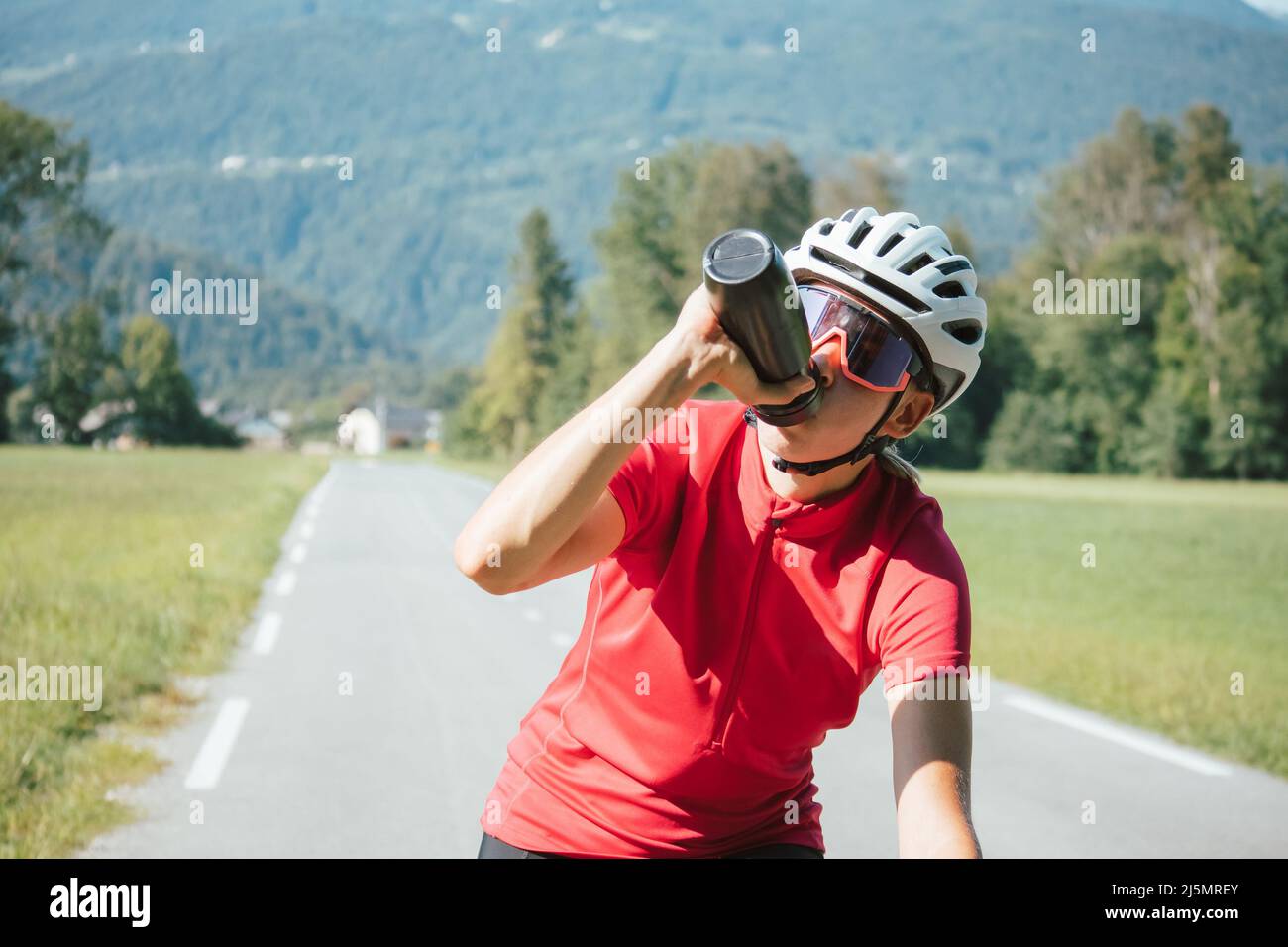 Cyclist drinking water during cycling hi-res stock photography and ...