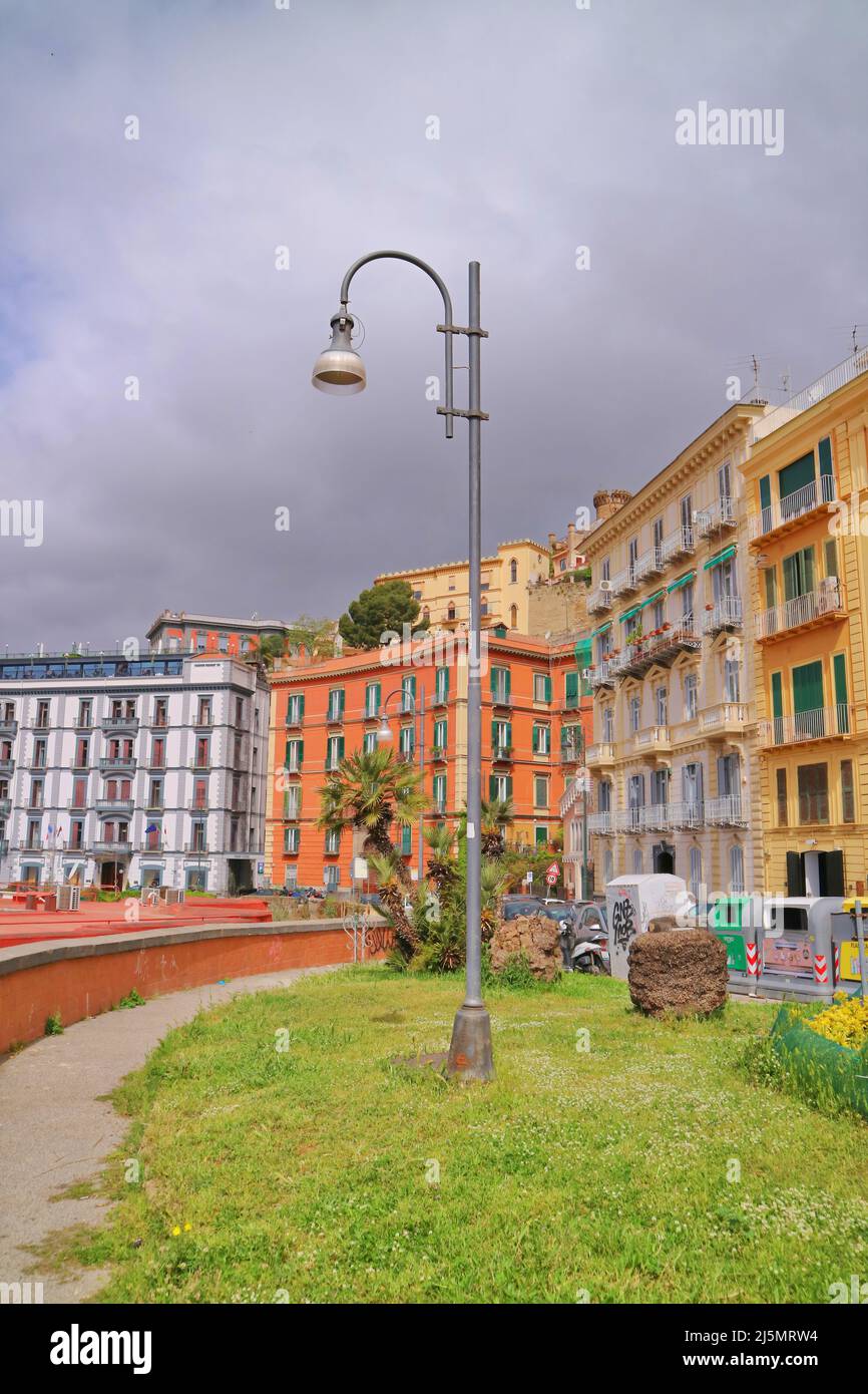 A street between ancient buildings in the historic center of Naples, a ...