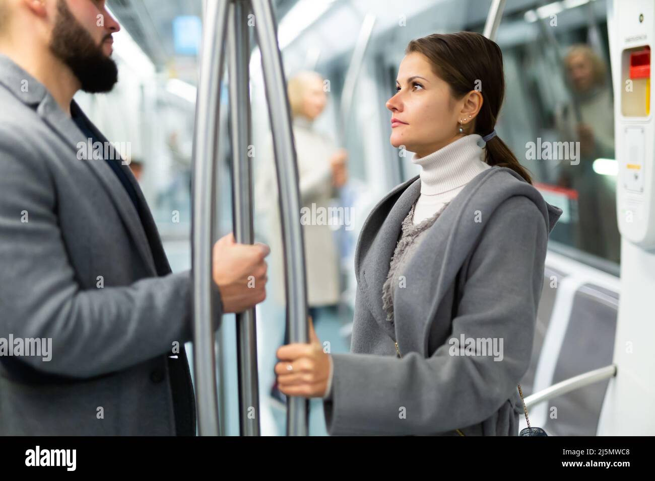 Happy passengers flirting in subway and smiling Stock Photo - Alamy