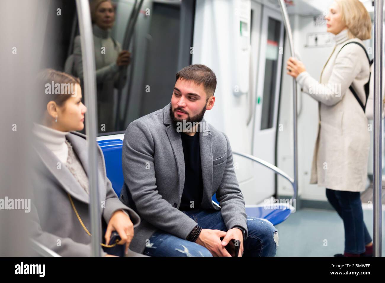 Portrait of playful positive people making acquaintance in public ...