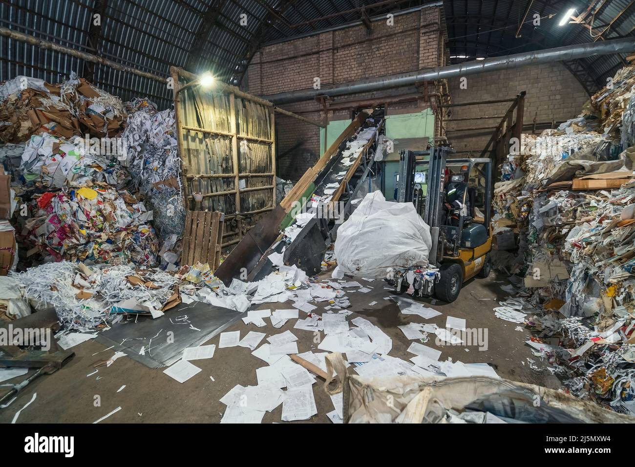 Waste paper sorting and filing for processing at paper recycling plant ...