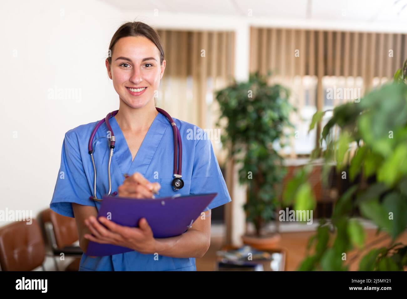 Woman doctor wear white medical uniform with folder of documents Stock ...